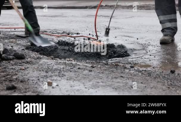 pothole repair - maintenance service workers working on the road Stock ...
