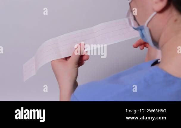The Cardiologist Shows The Film Of An Electrocardiogram Of A Patient