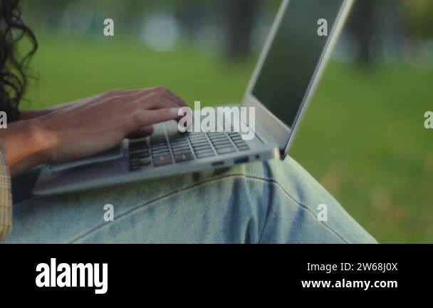 Close-up female hands fingers typing on keyboard keypad laptop computer ...