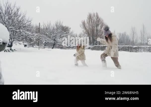 winter family activity outdoors. side view. Happy little girls ...