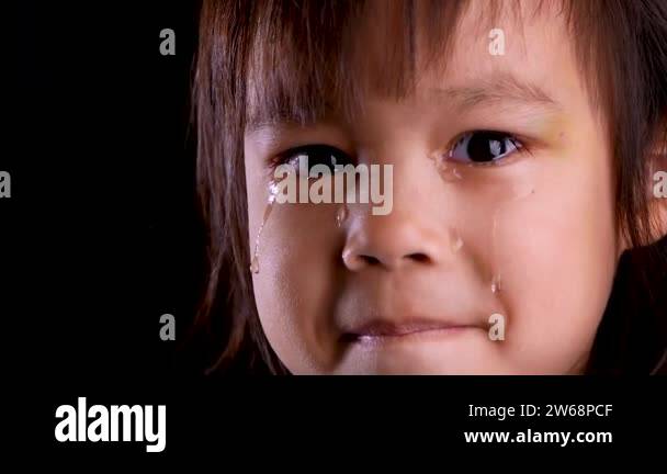 Close-up face portrait of sad little child girl looking at the camera ...