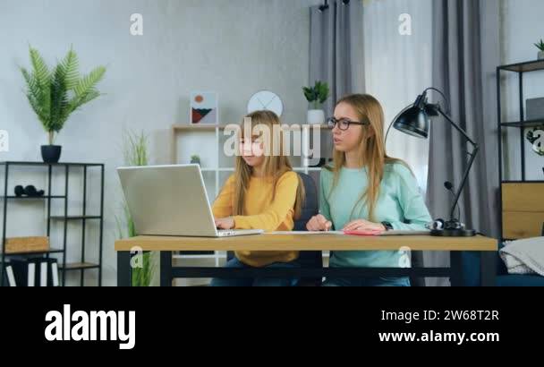 Adorable confident friendly two different ages sisters sitting in front ...