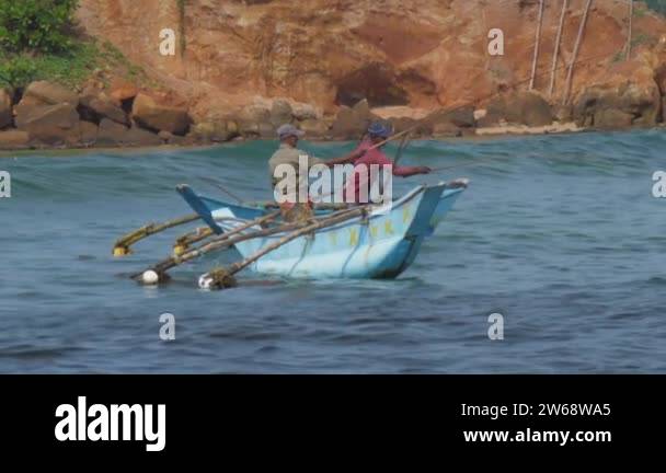 Fisherman with rod in traditional wooden boat with balancer Stock Video ...