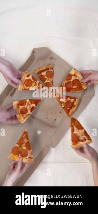 grabbing a slice of pepperoni pizza from a box in a boomerang motion ...