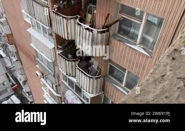 Open balcony with old stuff on a multi-story apartment building facade ...