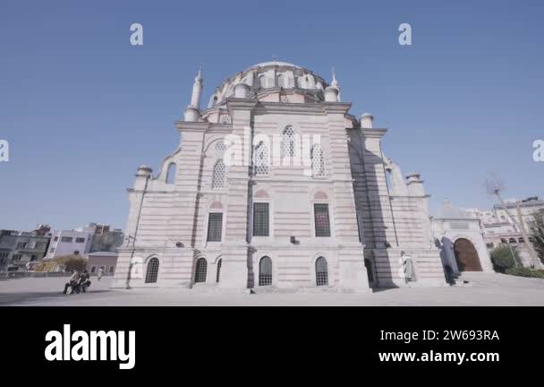 Bottom rear view of a giant muslim mosque on blue sky background ...