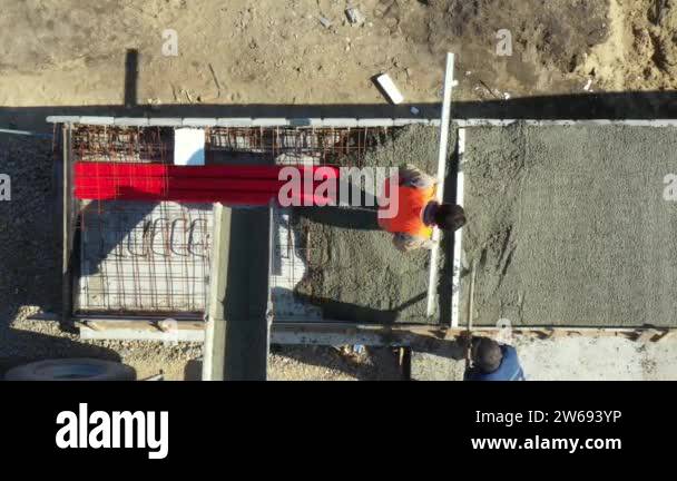 Above top view, overhead on construction worker, as he using shovel to ...