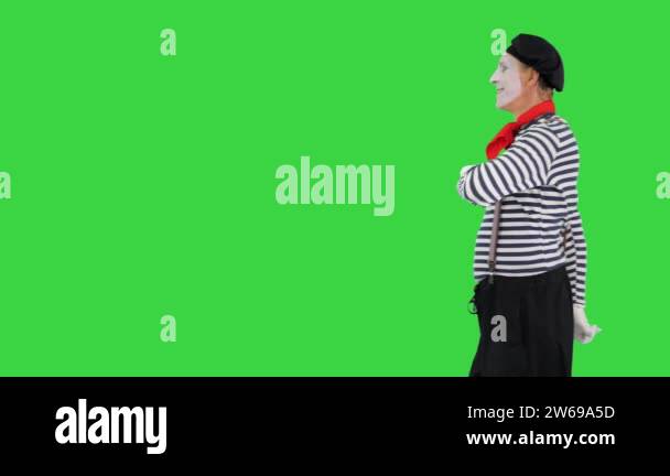 Mime playing a pantomime performance walking and opening imaginary door ...