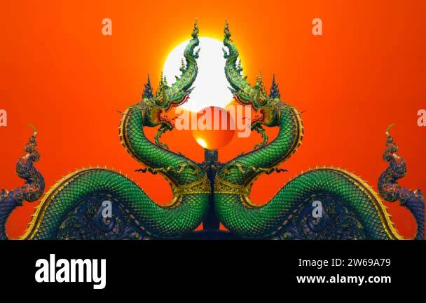 Two Naga status and pole in middle and sunset dark red sky on top of ...