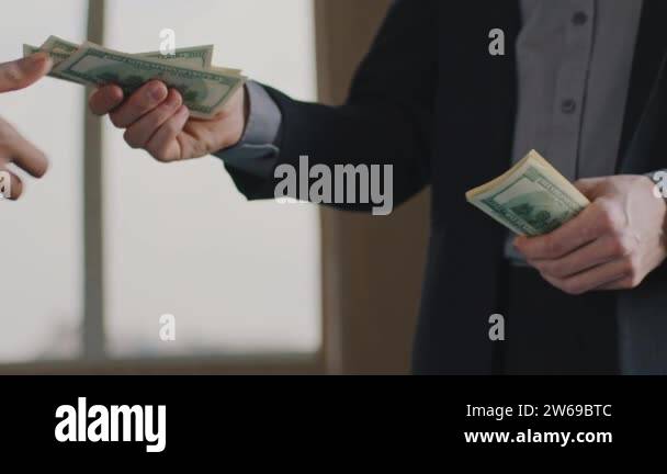 Close-up of two multiethnic unrecognizable business men partner sharing ...