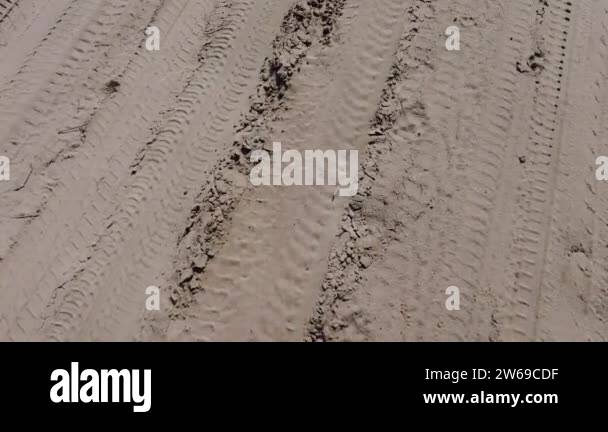 tire marks on the road. sandy road. Car wheel tread trace on the sand ...