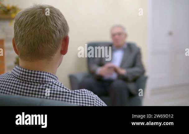 Two people communicate. The man is interviewing. Man with smartphone ...