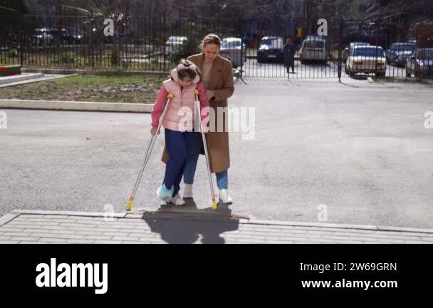 Mom Helps Her Daughter Learn To Walk On Crutches Broken Ramp And A