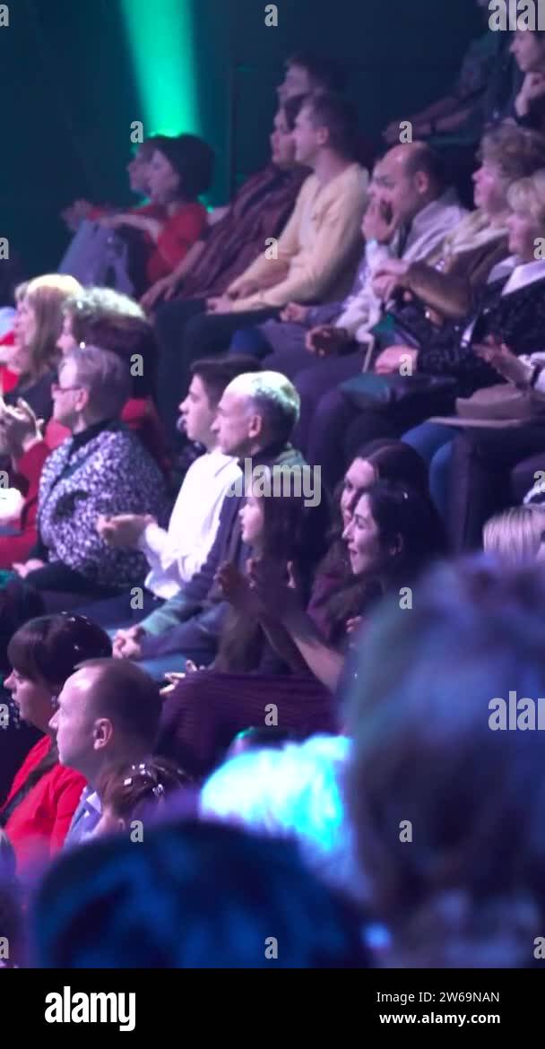 People viewers in a TV studio while recording a TV show. Vertical video ...