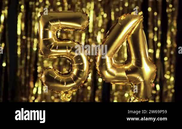 The golden number 54 fifty four is made from an inflatable balloon on a ...