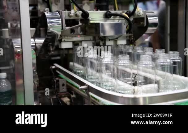 Clear Glass bottles transfer on Automated conveyor systems industrial ...