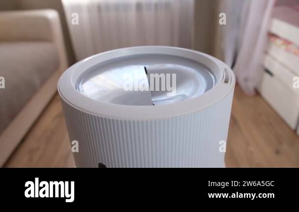 Steam from modern air humidifier, aroma oil diffuser at home. Improving the comfort of living in ...