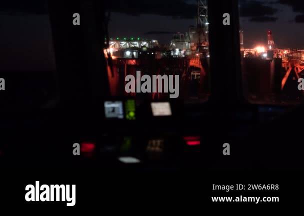 Drilling offshore platform in lights. View from windows of the ships ...