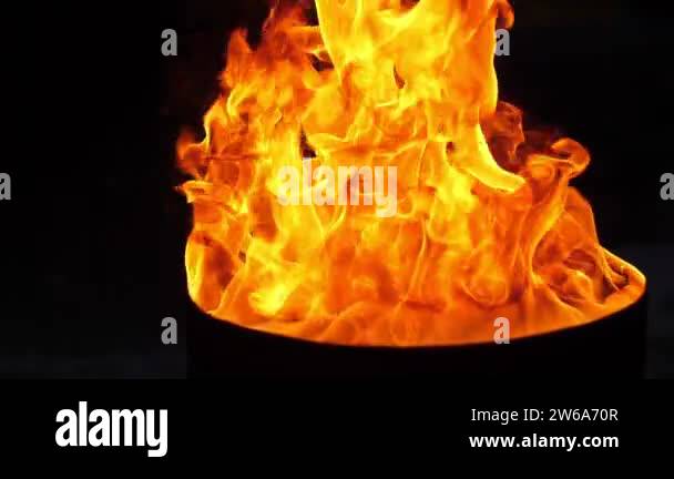 Flashes of yellow, red and orange fire dancing on the black background ...