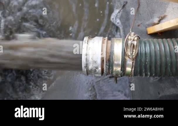 Close-up big pipe of power pump machine pouring mud sludge waste water ...