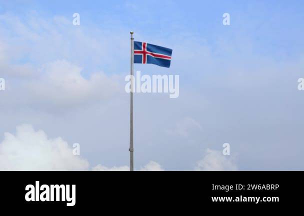 3D, Icelandic flag waving on wind with blue sky and clouds. Iceland ...