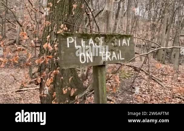 This panning video shows an outdoors safety sign that reads - please ...