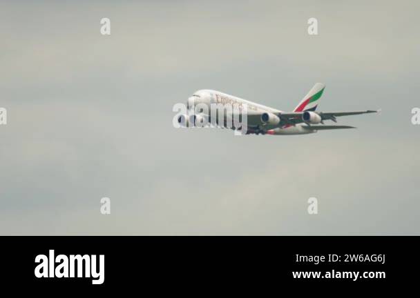 Emirates Airbus A380 flies in the gray cloudy sky Stock Video Footage ...