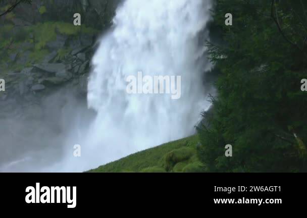 Mountain waterfall. A fast mountain river falls down a cliff. The ...