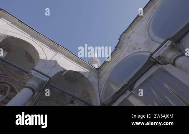 Bottom view of a white temple details with arches and long spire ...