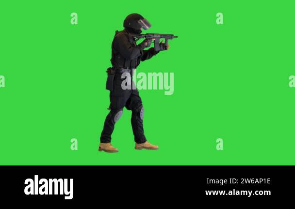 Tactical police unit in black uniform reloading an assault rifle on a ...