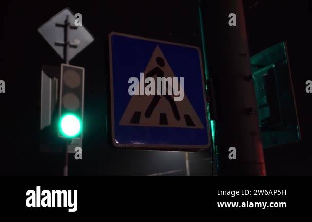 Night city street scene, zebra crossing, blue pedestrian cross warning ...