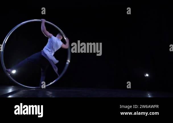 Circus artist shows concentration and balance while spinning on a Cyr ...