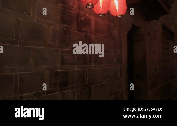 Bottom to up close-up stone wall and balcony of Chinese temple at night ...