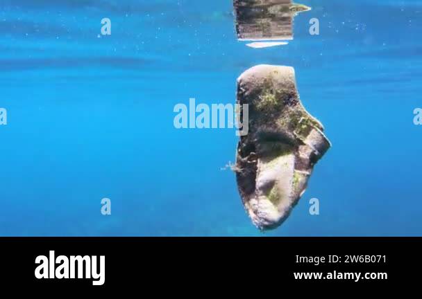 Ocean Pollution In Papua, Indonesia. Underwater View Of Floating Shoe ...