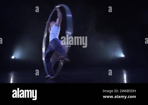 Circus artist shows concentration and balance while spinning on a Cyr ...