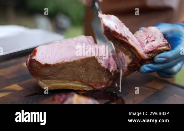Professional chef using sharp cooking knife for separate medium rare ...