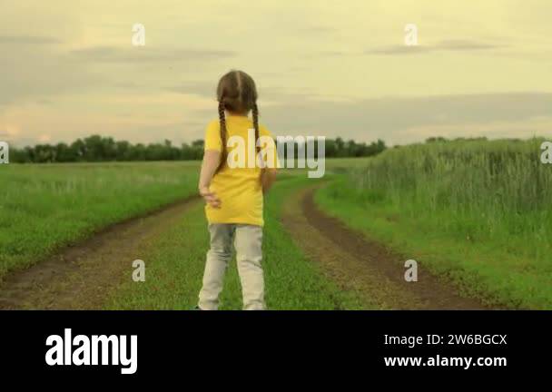 little girl runs along road, active cheerful kid, countryside, happy ...