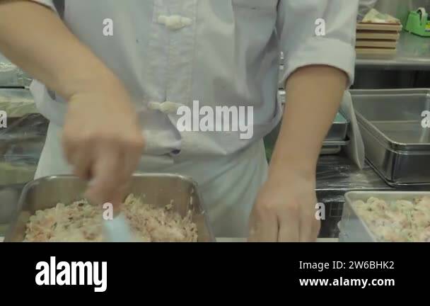 Making Dim Sum. Chef preparing Dim sum dumplings. Kneading the dough ...