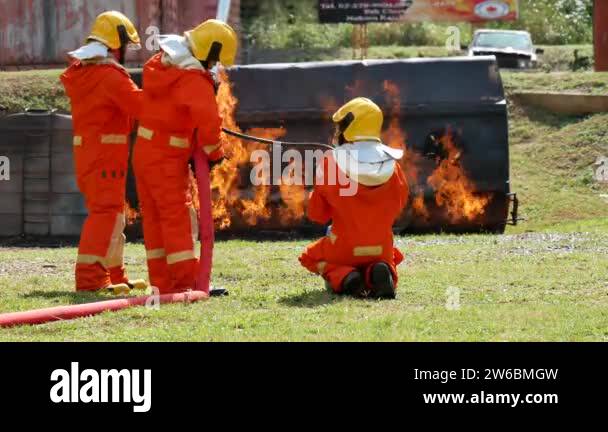 Firefighter fighting with fire flame protection property. Fireman wear ...
