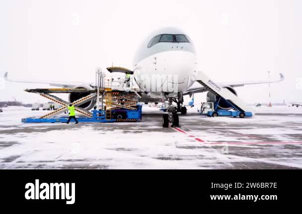 Ukraine, Boryspil - February 12, 2021: Airport in winter. Aircraft maintenance - baggage loading ...