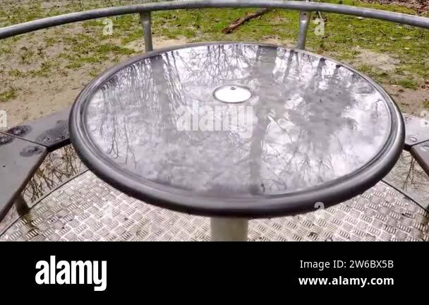 Silky waves on a playground after heavy rain in a forest on a carousel ...