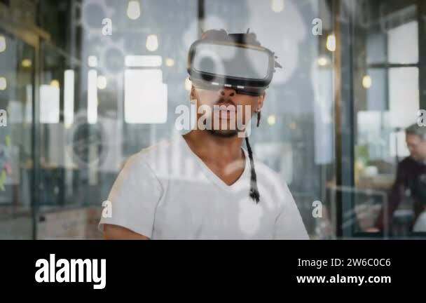 Animation of social media icons and data processing over african american man wearing vr headset ...
