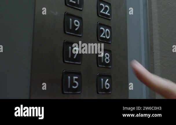 Push Button. Hand pressing lift button up to high floor of office ...