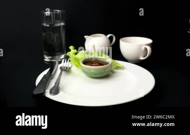 Putting a piece of salmon fish and broccoli quiche in white ceramic ...