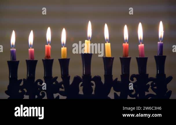 Candelabrum (hanukkiah) and colorful candles burning on the eight day ...