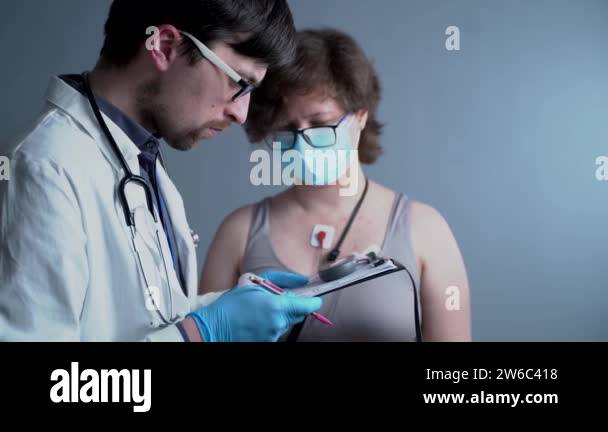 Young caucasian male doctor cardiologist do cardiological examination ...