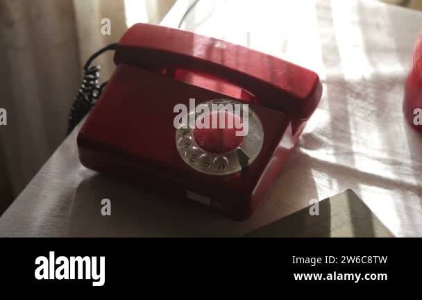 Ringing a red Rotary dial telephone. Dialing on an old rotary style ...