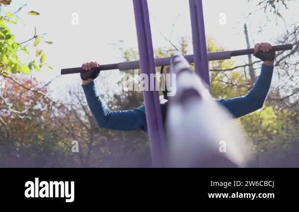 Strong Grey-Haired Man With Dreadlocks exercising With a training ...