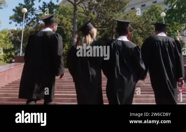 Happy group of multiracial students graduates with graduation caps ...