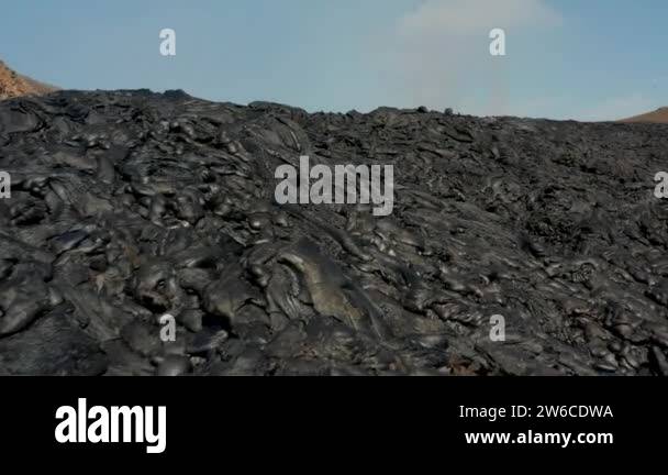 Low flights above piles of accumulated material in cooling lava stream ...